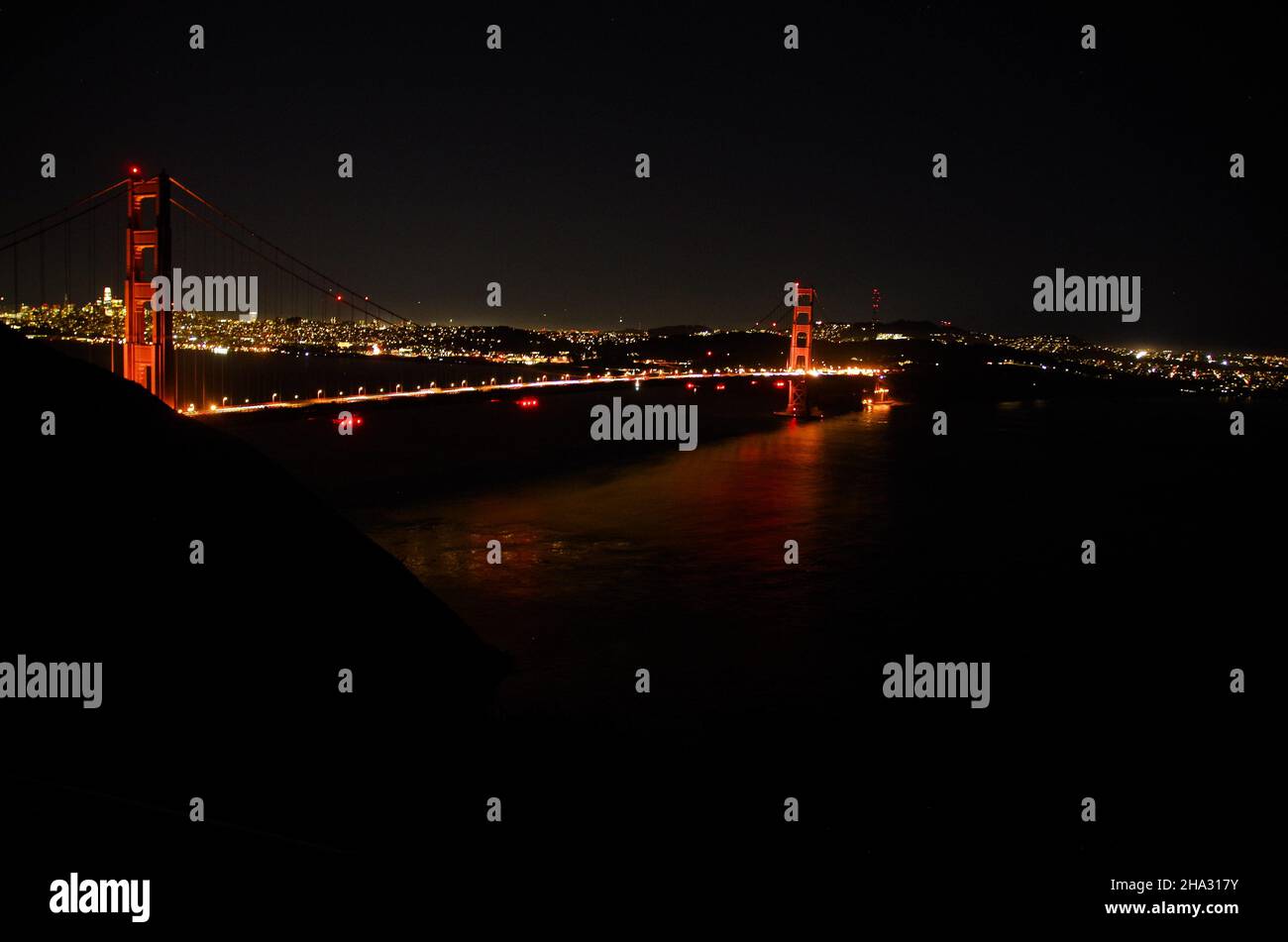 Aerial view of the illuminated Golden Gate Bridge at night Stock Photo ...