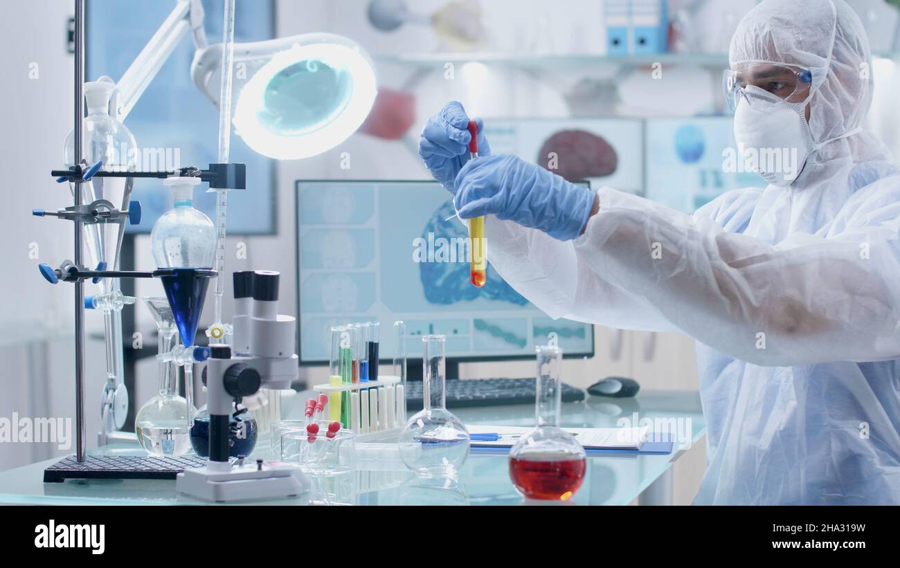 Microbiologist scientist doctor mixing medical liquid solution ...