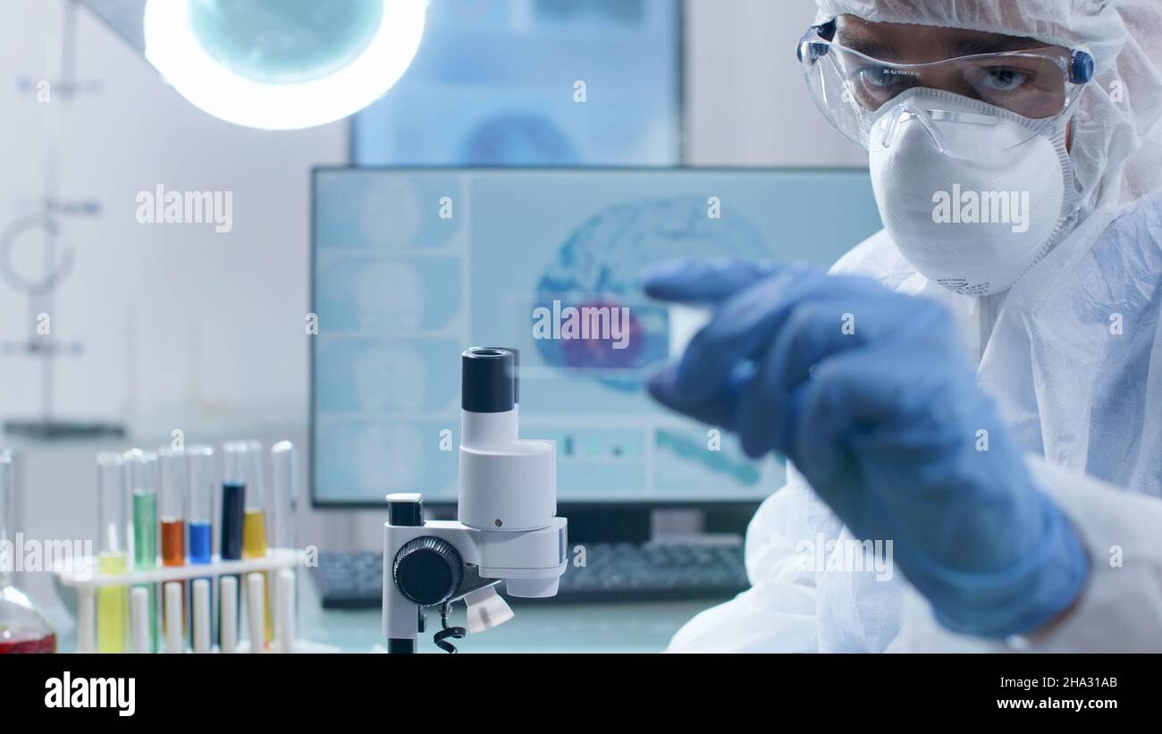 Specialist researcher holding microscope slide analyzing blood sample ...