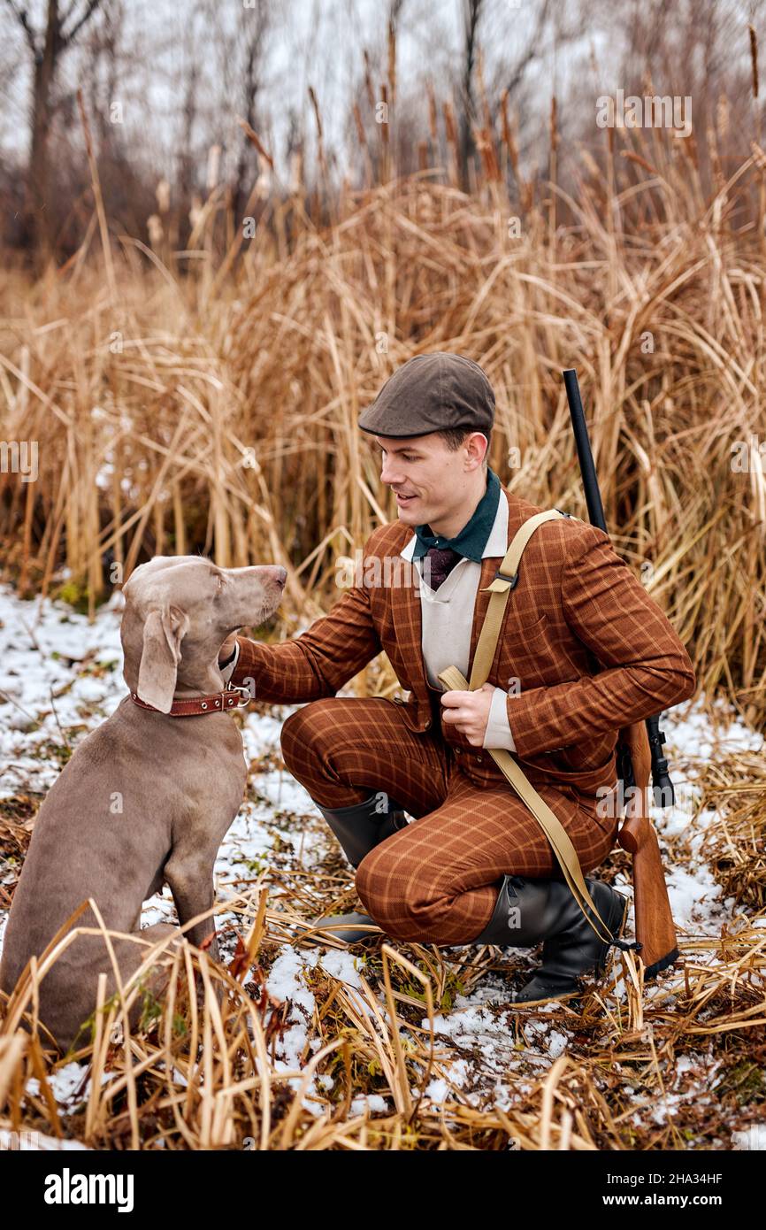 Hunting period, autumn season open. male hunter with gun in suit, in ...