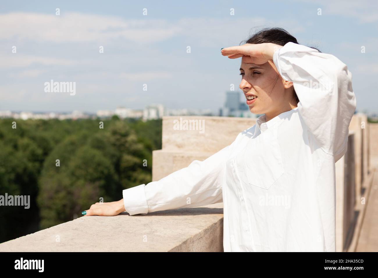 Tourist woman looking at metropolitan city panoramic view from building ...
