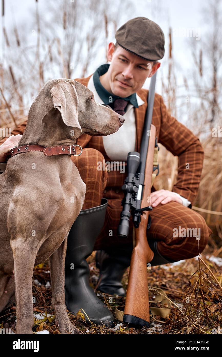 Hunting period, autumn season open. hunter with gun in suit in the ...