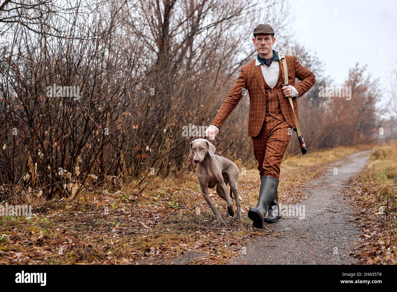 handsome caucasian male hunter in trendy brown suit ready to hunt ...