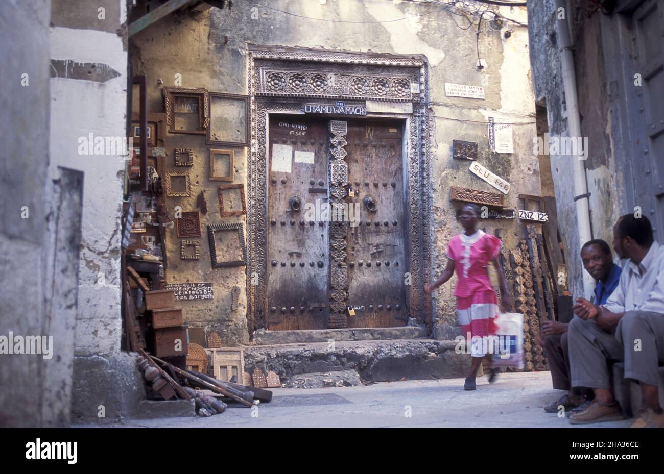 a local Women at a traditional Wood Door in the Old Town of Stone Town ...