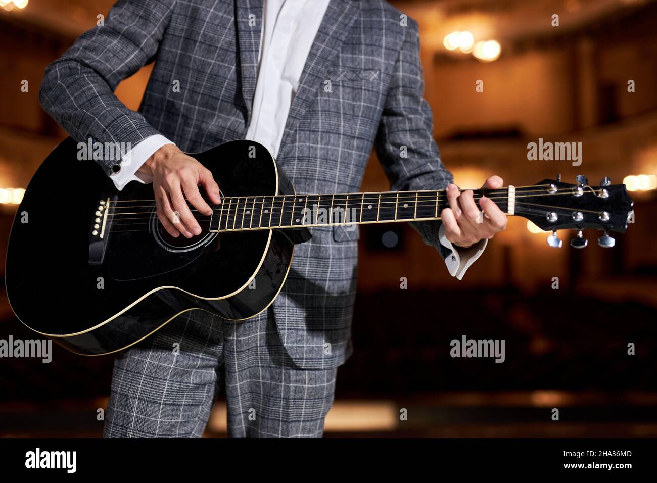 unrecognizable adult musician playing acousitc guitar, playing music ...