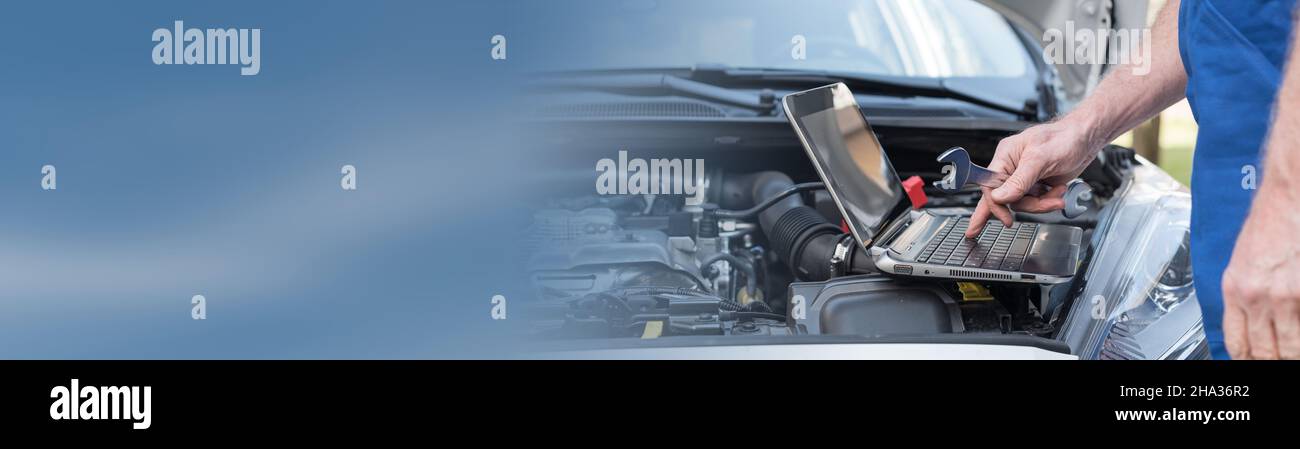 Car mechanic using laptop for checking car engine Stock Photo - Alamy