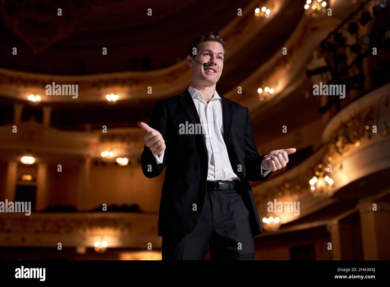 On Stage. Man in black formal suit tuxedo performing Startup CEO ...