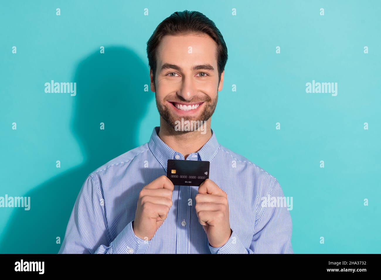 Photo of cheerful banker demonstrate debit card deposit option wear ...