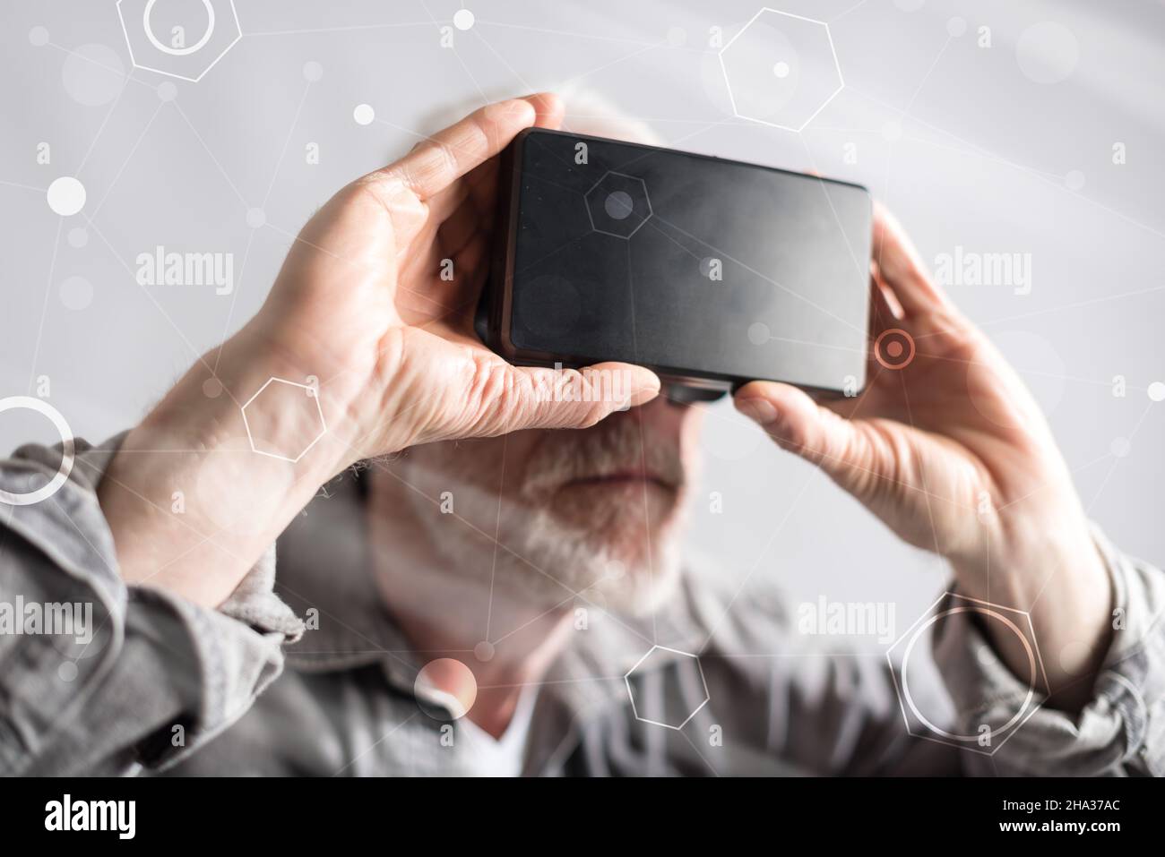 Senior man using a virtual reality headset, double exposure Stock Photo ...
