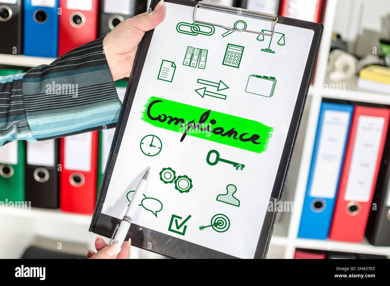 Woman holding a clipboard with compliance concept Stock Photo - Alamy