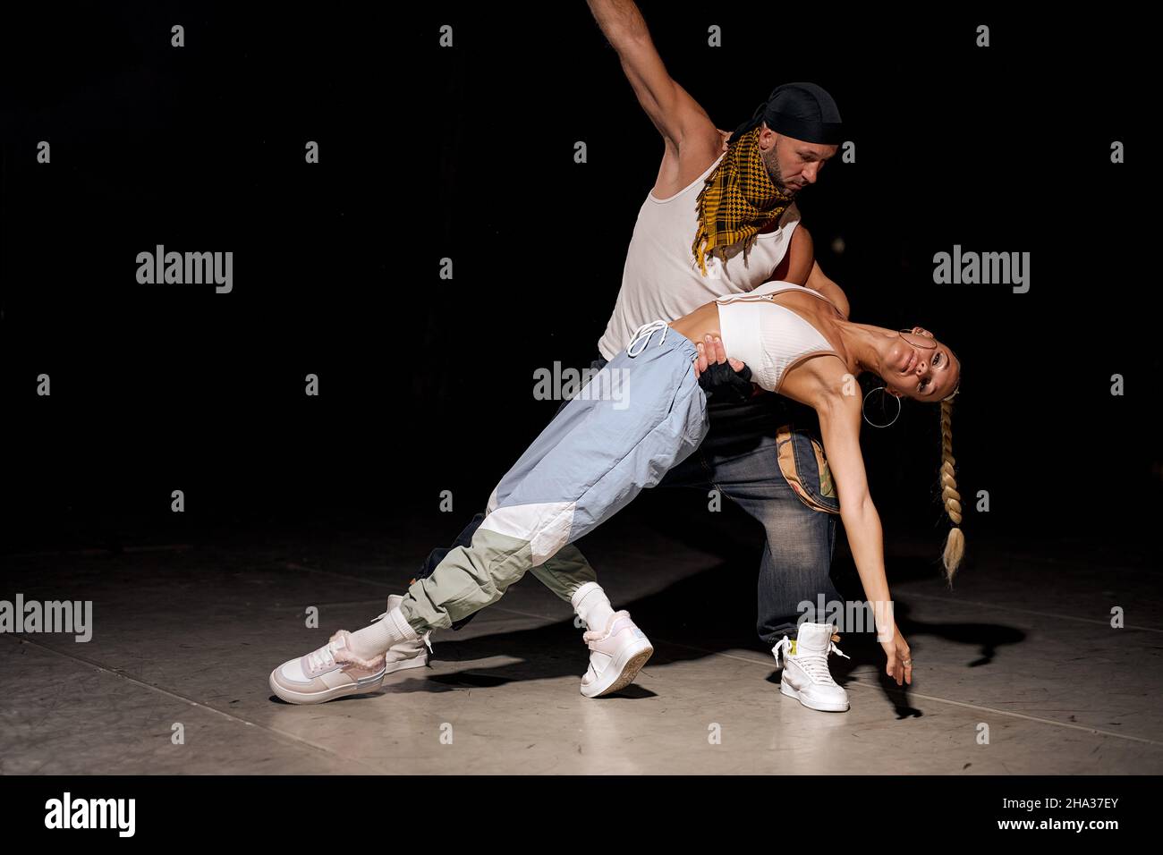 Modern. Fashionable young caucasian couple dancing hip-hop in stylish ...