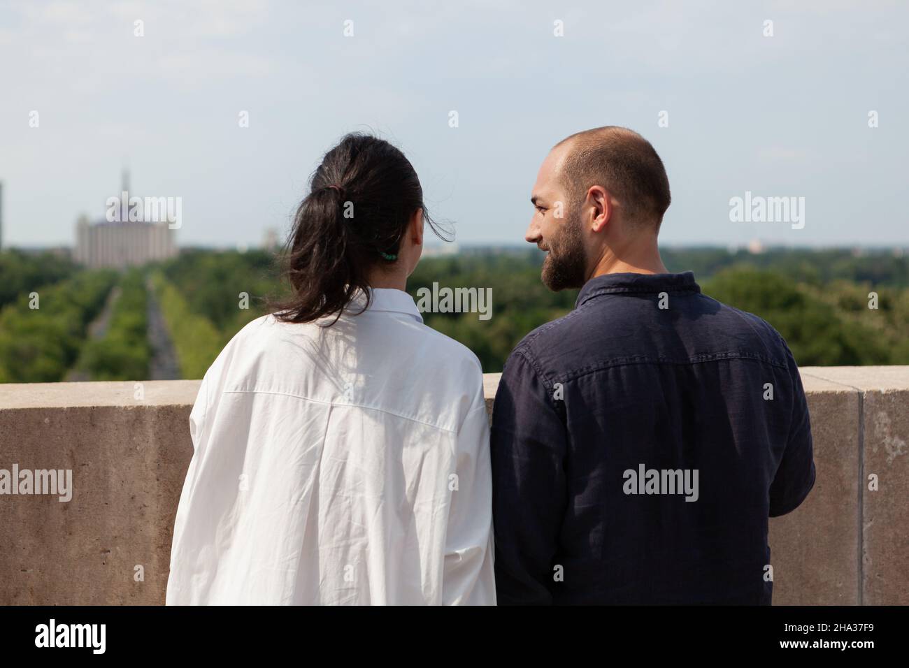 Happy couple enjoying romantic vacation standing on building roofttop ...