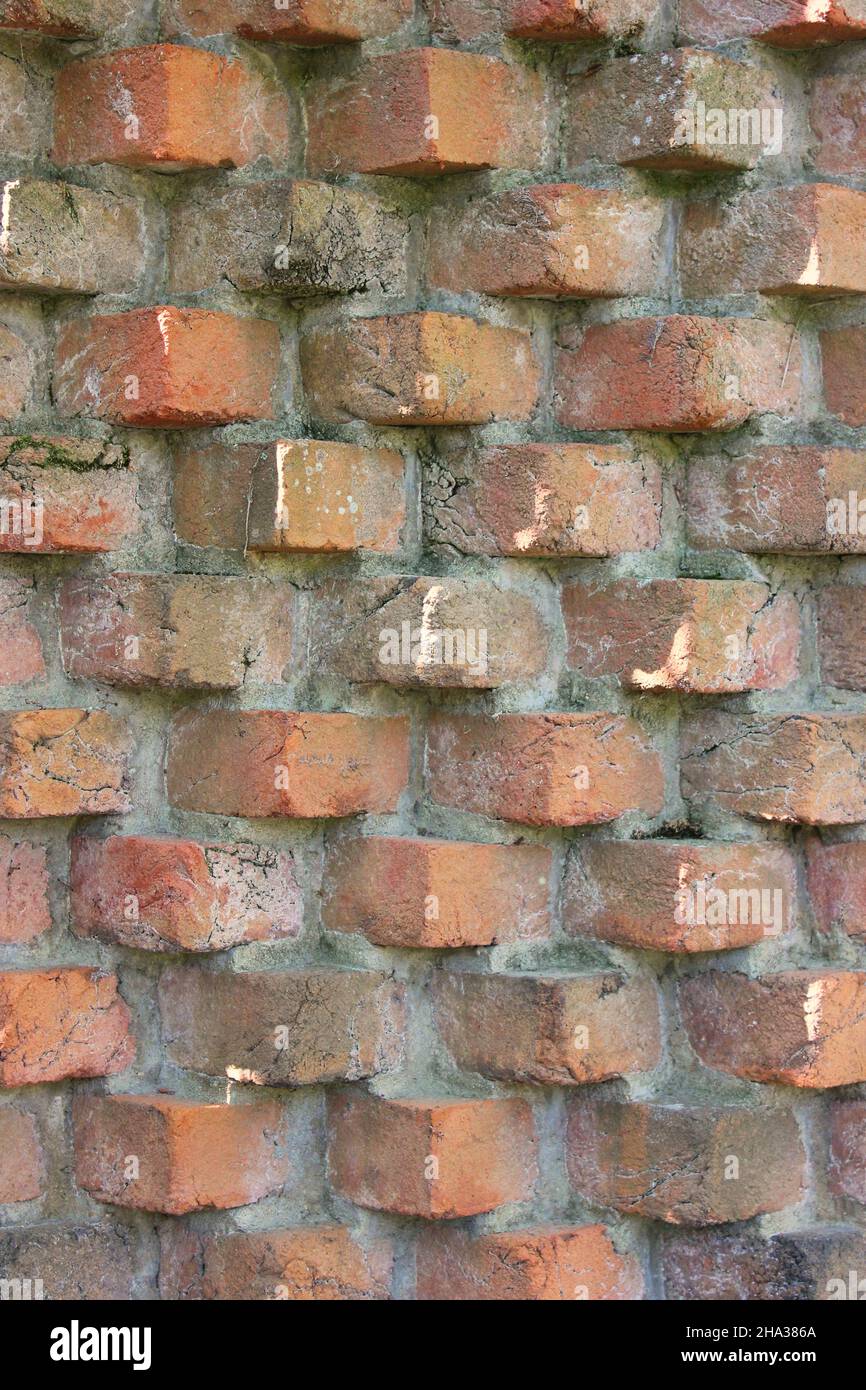 Unusual brickwork wall in the bright sun Stock Photo - Alamy