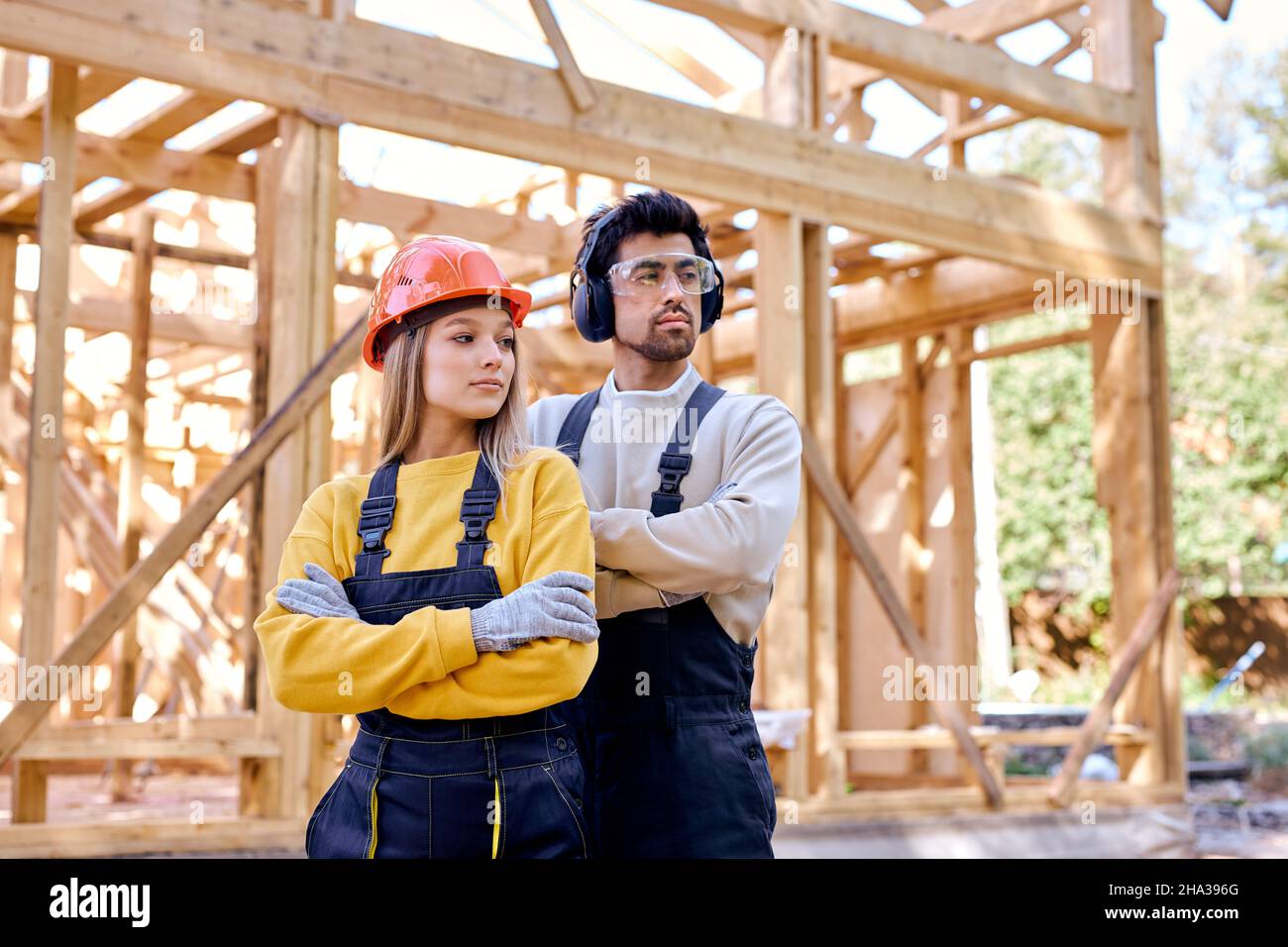 team of constructor engineers in New wooden residential construction ...