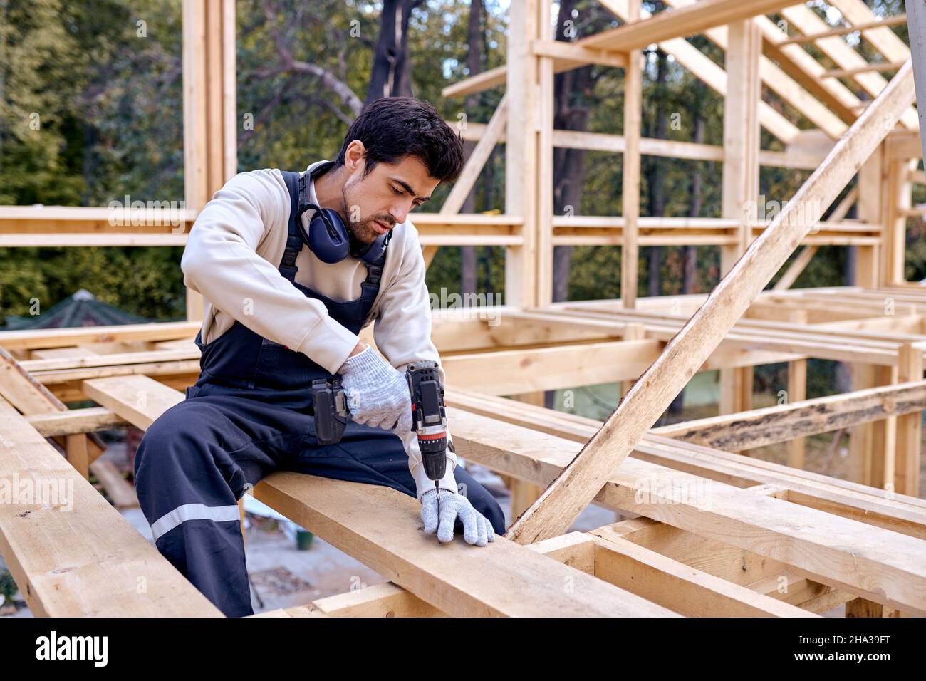 Hardworking Caucasian Contractor Working With Drill Driver. Focused ...