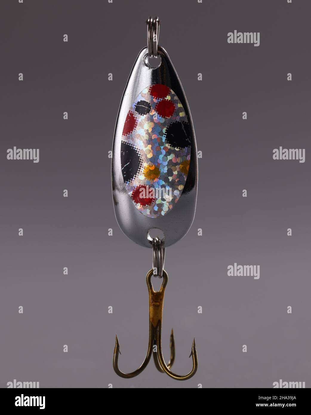 Triple metal spinner with fishing hooks on gray background. Fishing ...