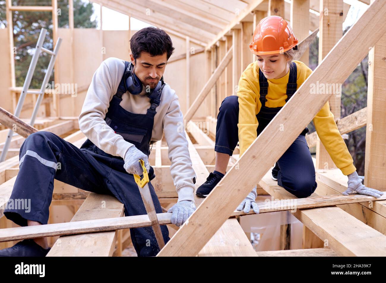 Caucasian Contractors Carpenters Workers Using Wood Saw in Construction ...