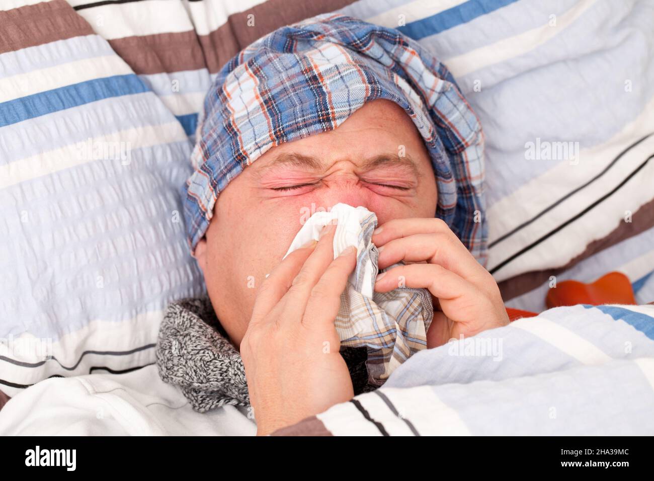 Man with handkerchief and hot water bottle human, red, nose, lying ...