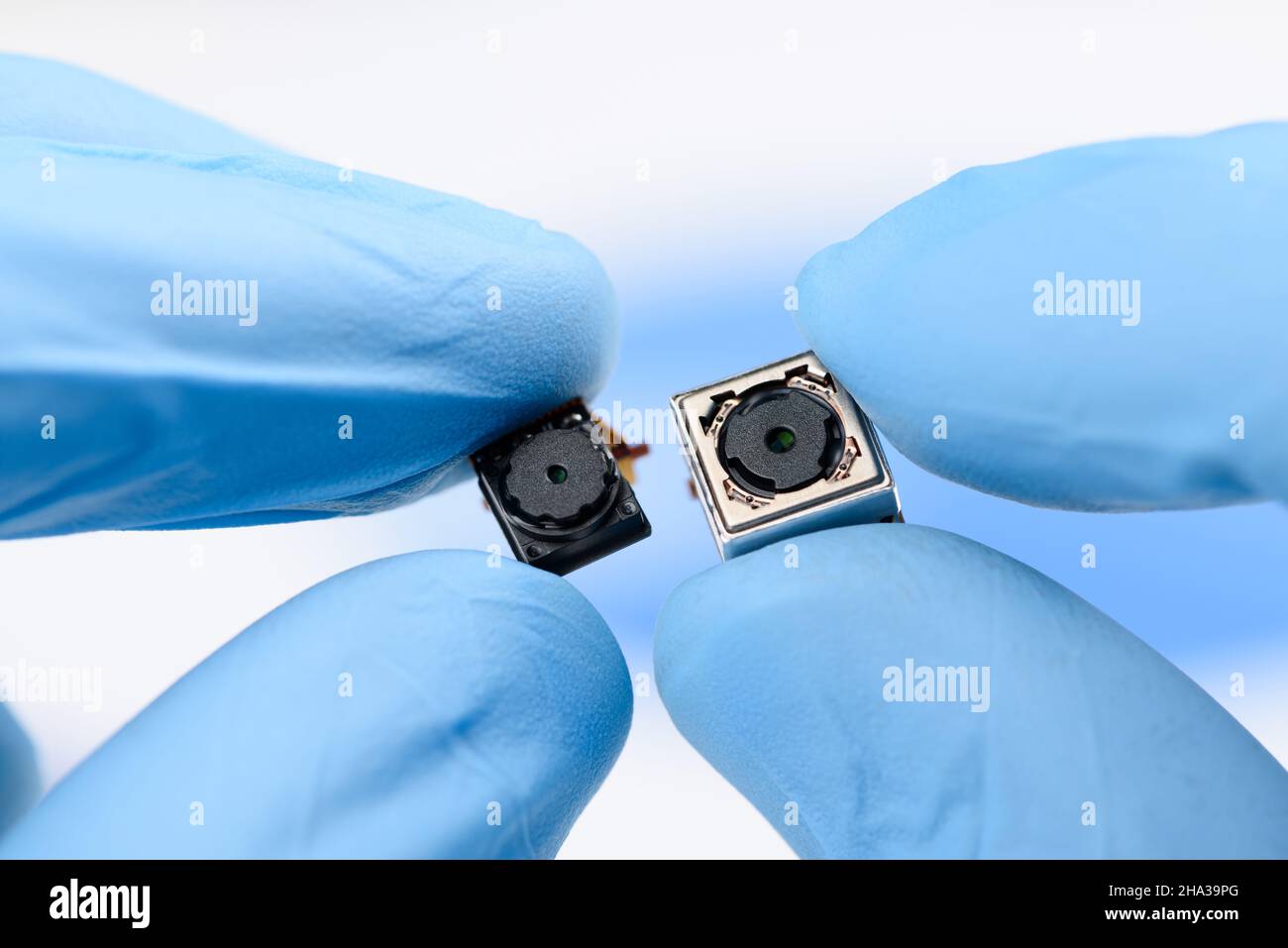 Two cell phone camera modules in scientist hands Stock Photo - Alamy