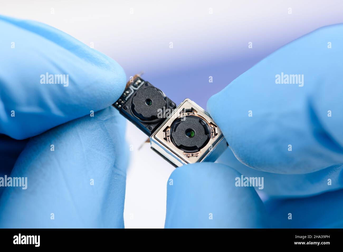 Two cell phone camera modules in scientist hands Stock Photo - Alamy