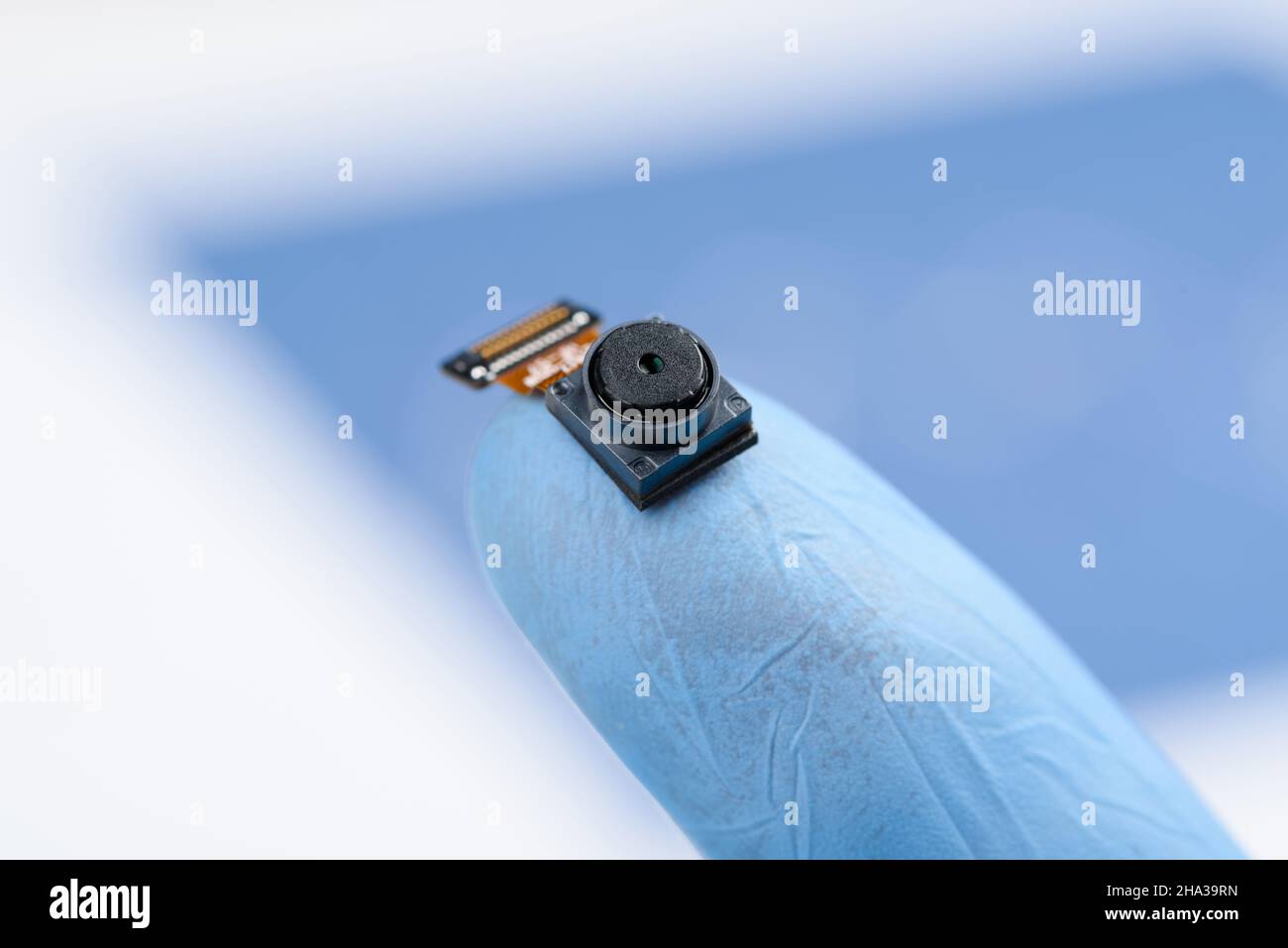 Camera module on fingertip. Smartphone cell phone small camera sensor ...