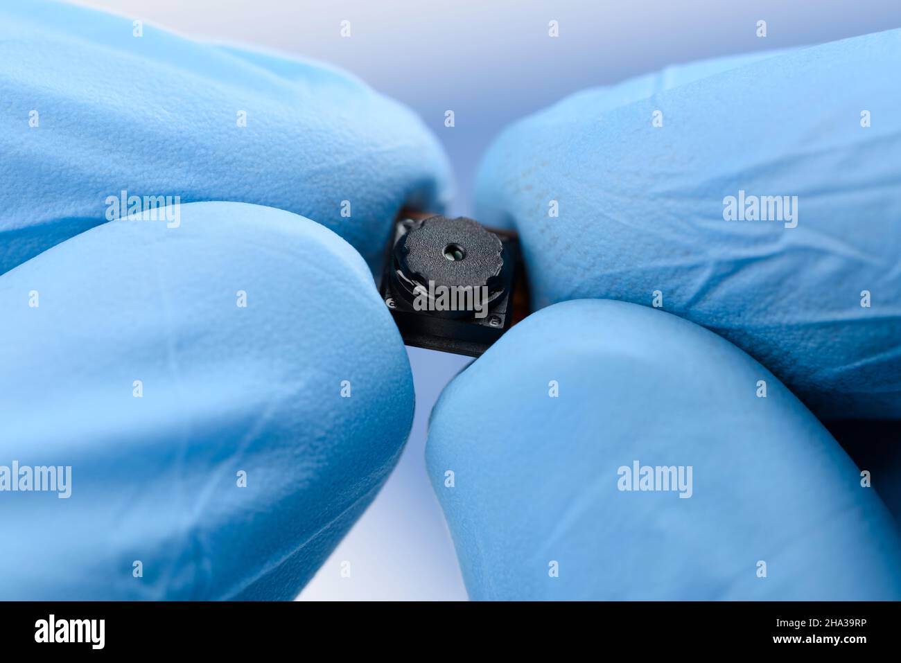 Tiny cell phone camera module in hands. Camera sensor technology ...