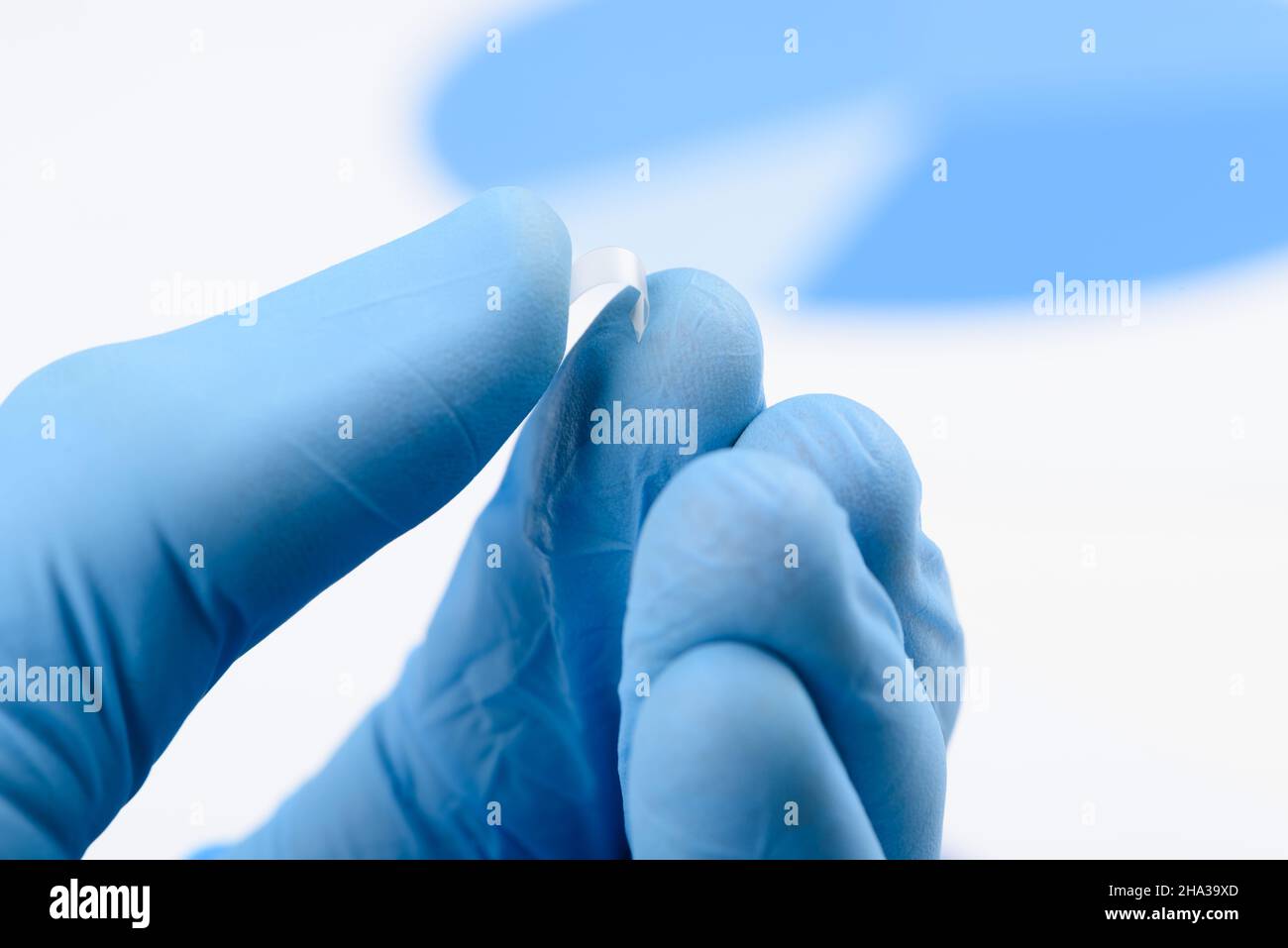 Scientist bend flexible transparent plastic like thin film material in ...