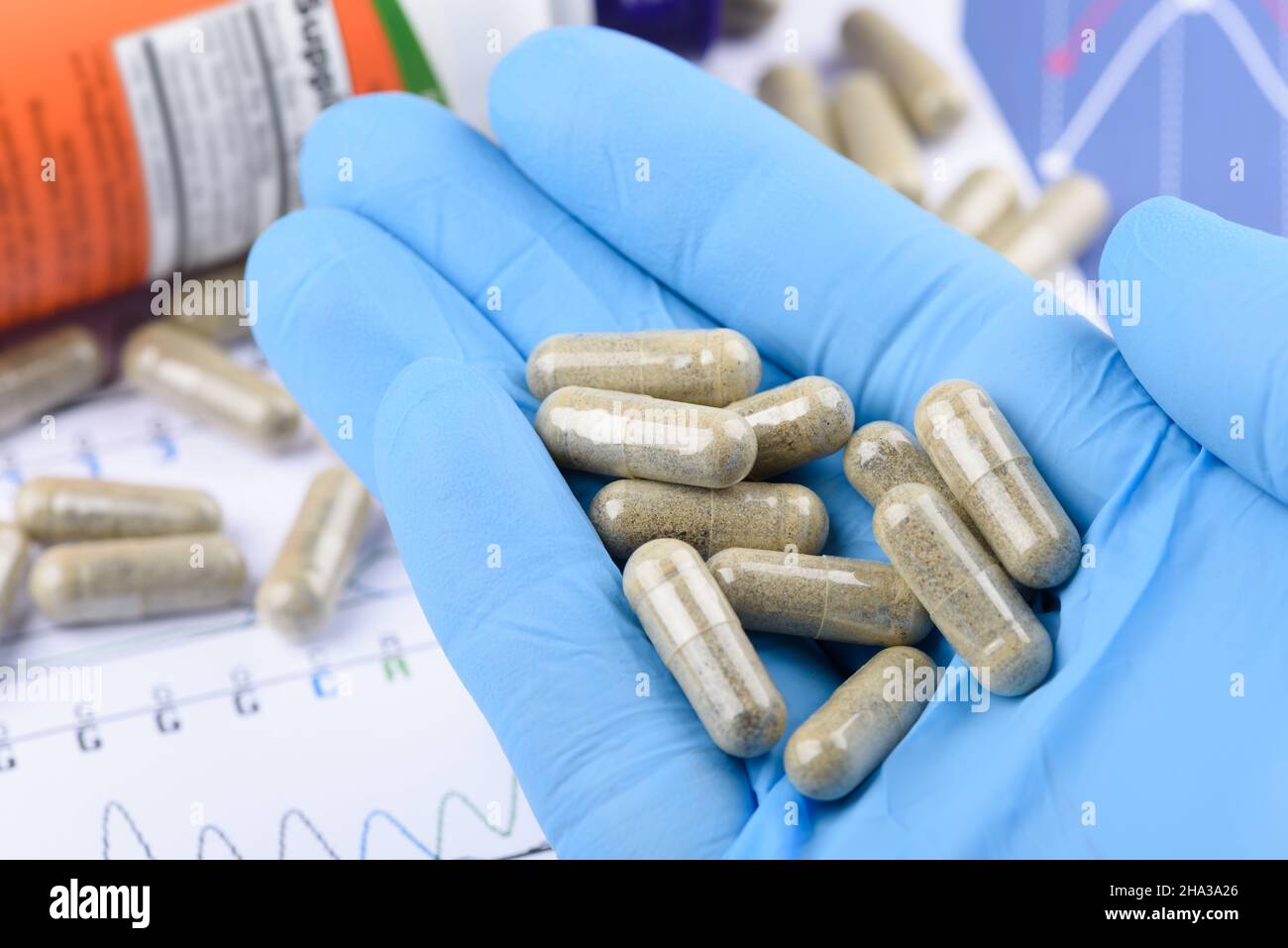 Supplement capsules in scientist hand Stock Photo - Alamy