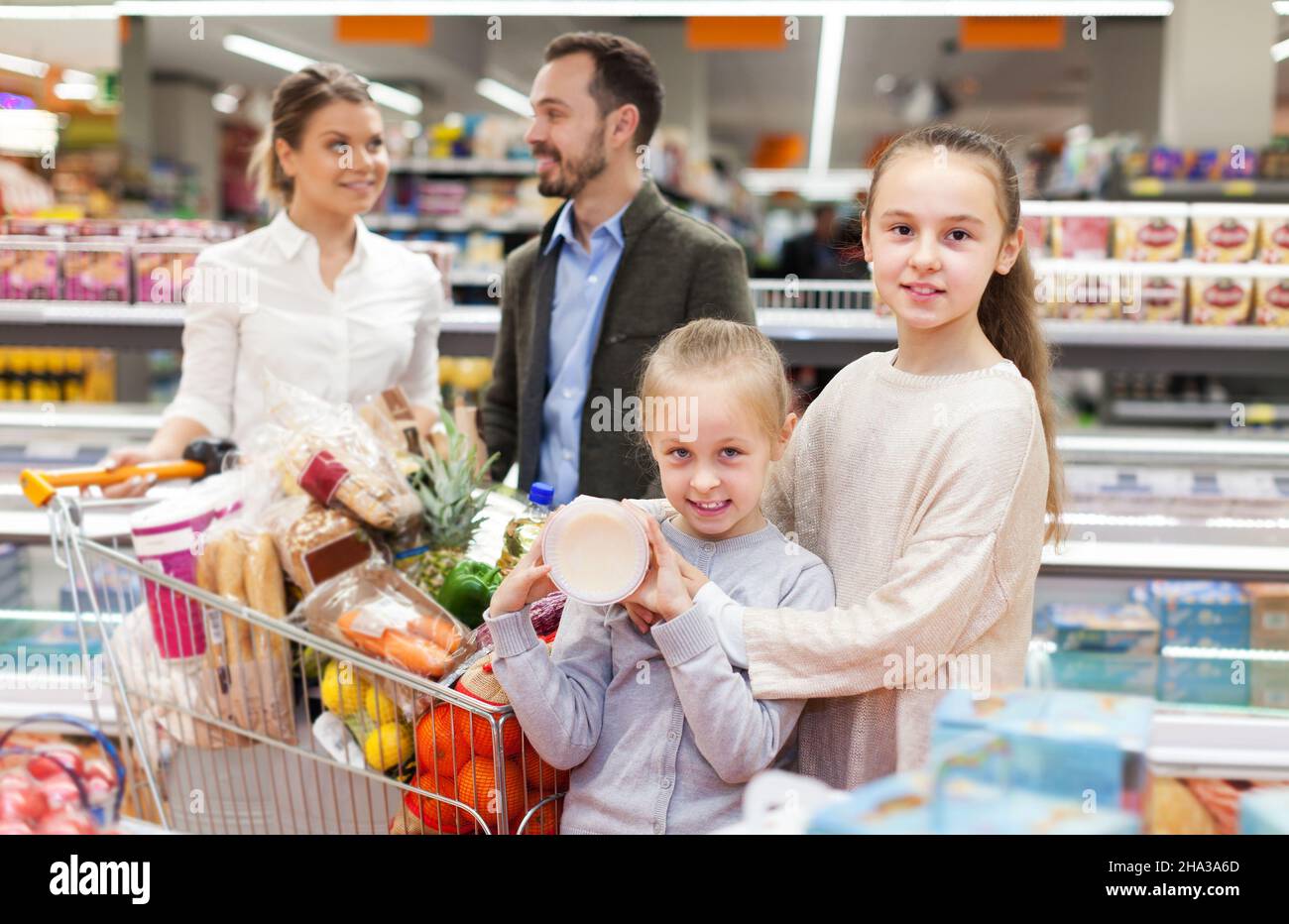 Family with purchases in supermarket Stock Photo - Alamy