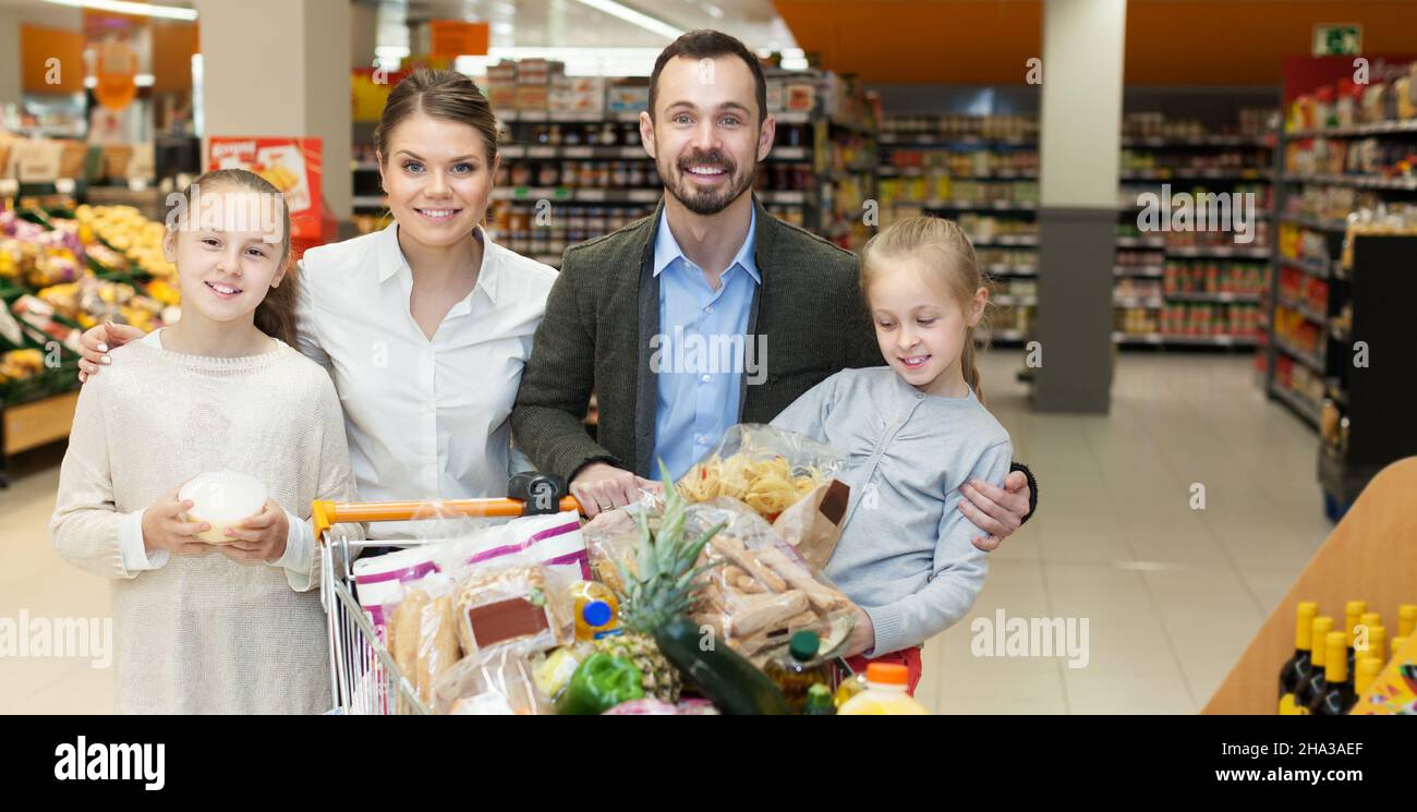Family with purchases in supermarket Stock Photo - Alamy