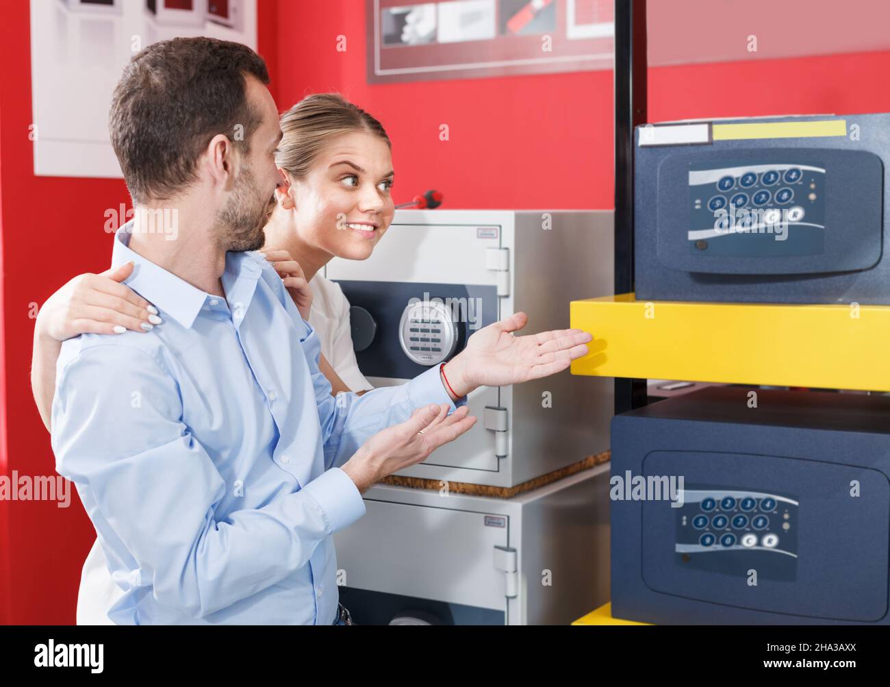 Positive family couple looking for new reliable safe box Stock Photo ...