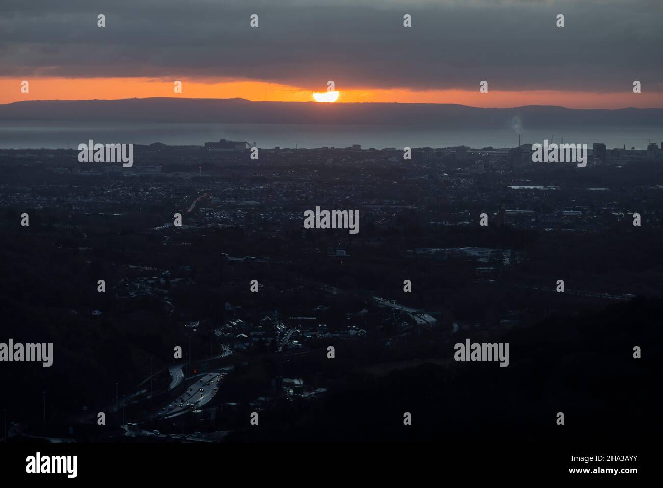 The sun begins to rise above the Bristol Channel and the city region of ...