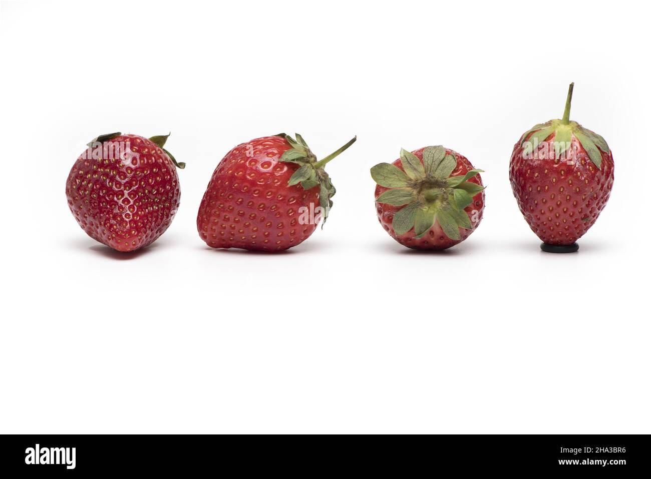 Close up of four strawberries seen from different views isolated on ...