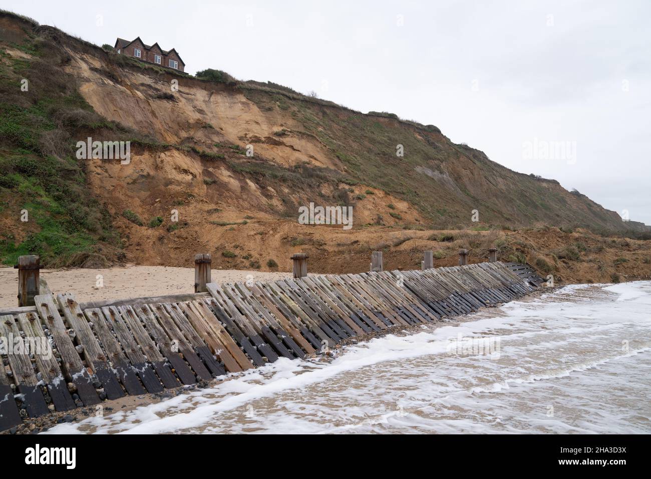 Houses sit close to the edge after a cliff collapse at Mundesley in ...