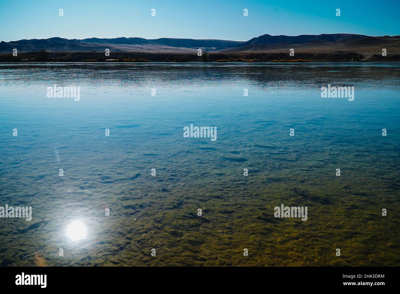 The reflection of sunlight in the blue water. Steppe River Stock Photo ...
