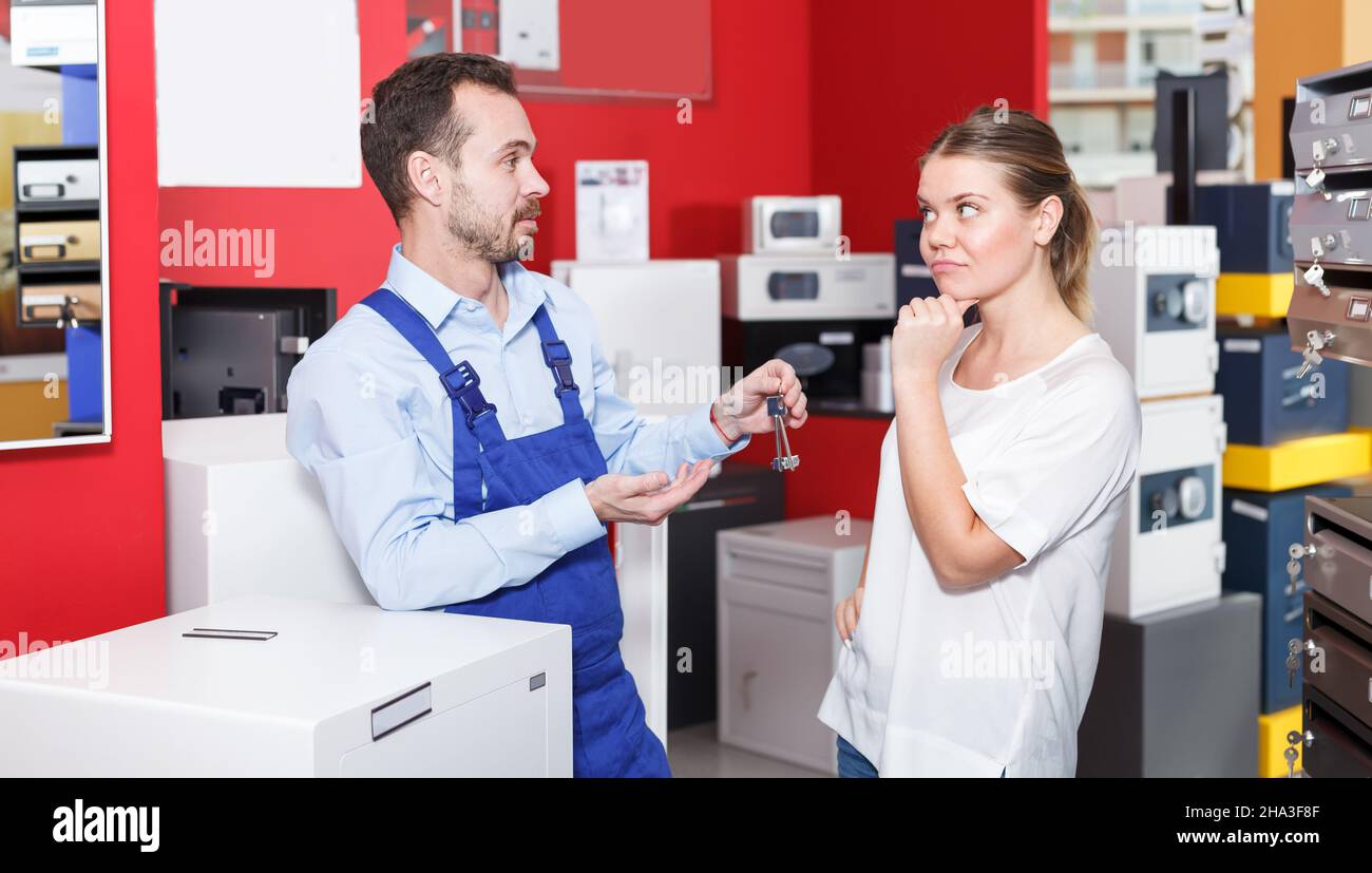 Confident man proffering keys to nice client Stock Photo - Alamy