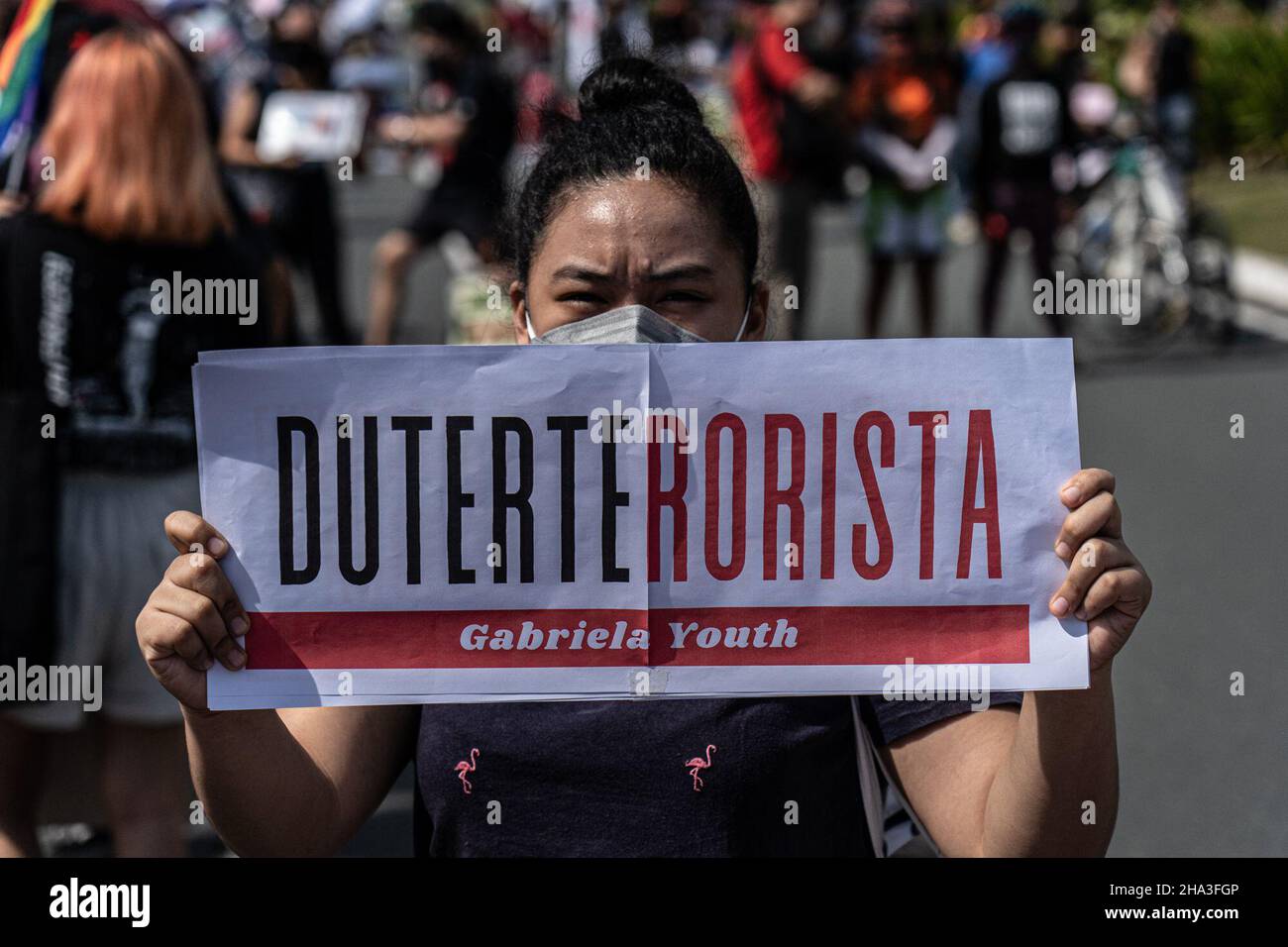 Metro Manila, Philippines. 10th Dec, 2021. An activist holding slogan ...