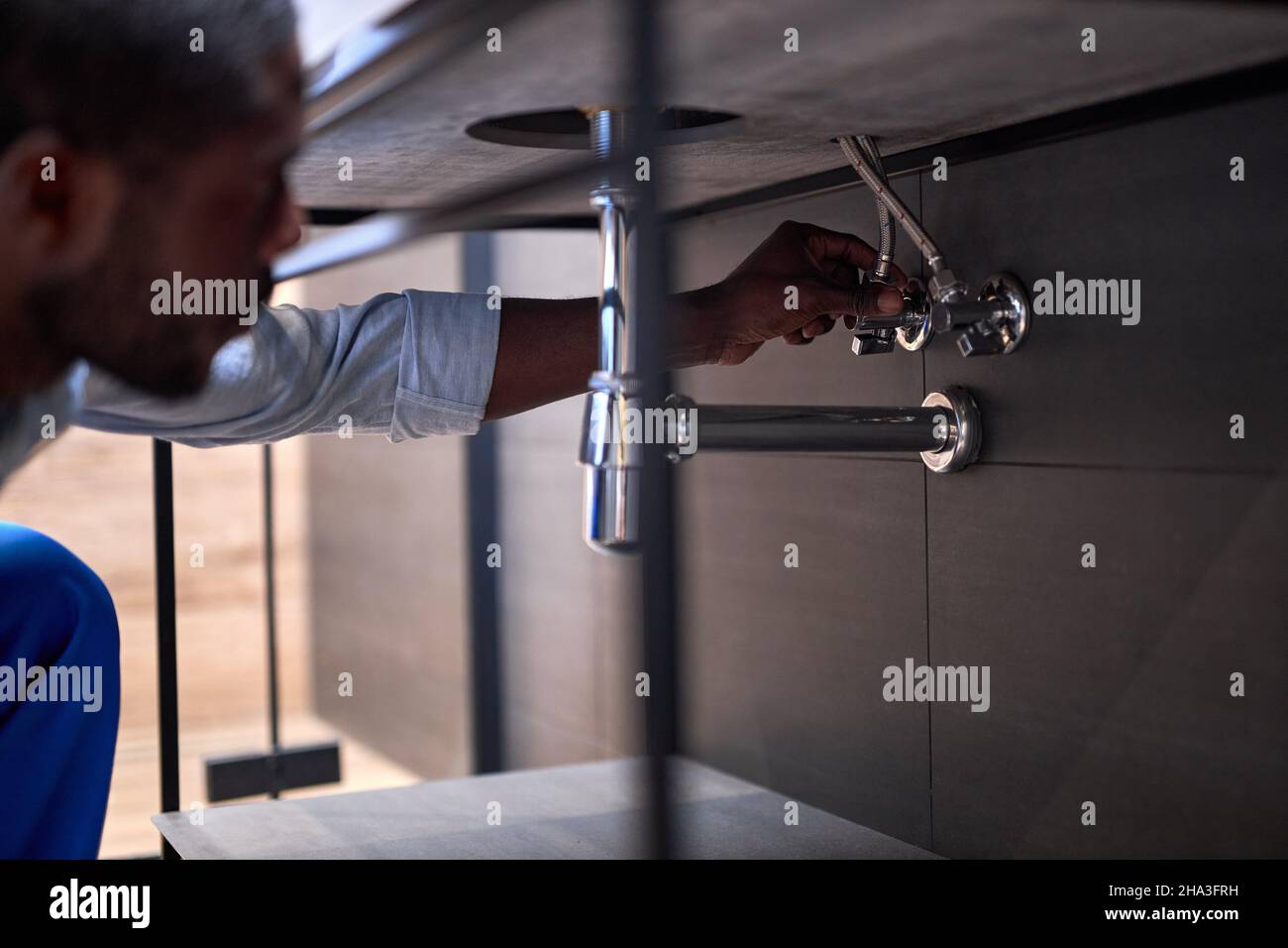 Afro american professional Plumber working in bathroom at home, skilled ...