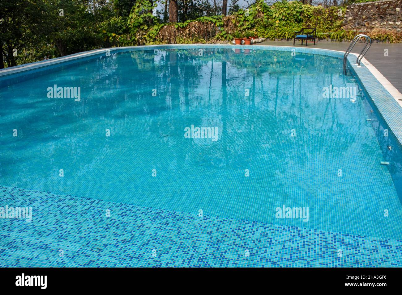 Swimming pool with blue and clear water Stock Photo - Alamy