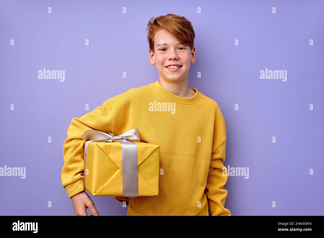 Excited happy pleased little boy holding gift box in hands, attractive ...