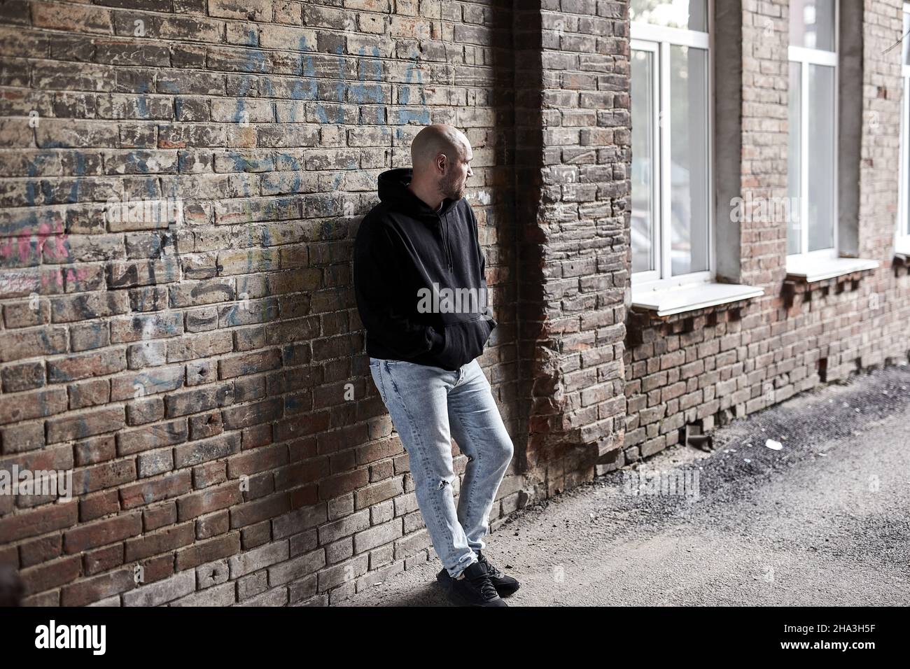Side view on young caucasian man waiting for victim, looking at side ...