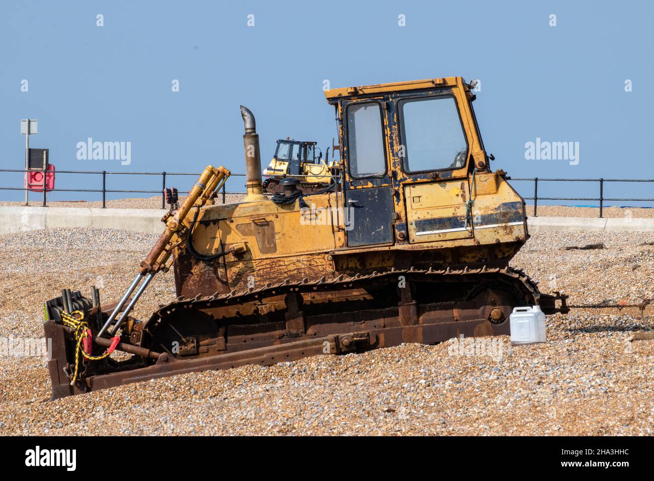 Old yellow rusting bulldozer on a seafront beach on a dull day Stock ...