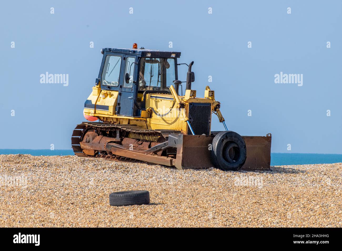 Digger on the beach yellow hi-res stock photography and images - Alamy