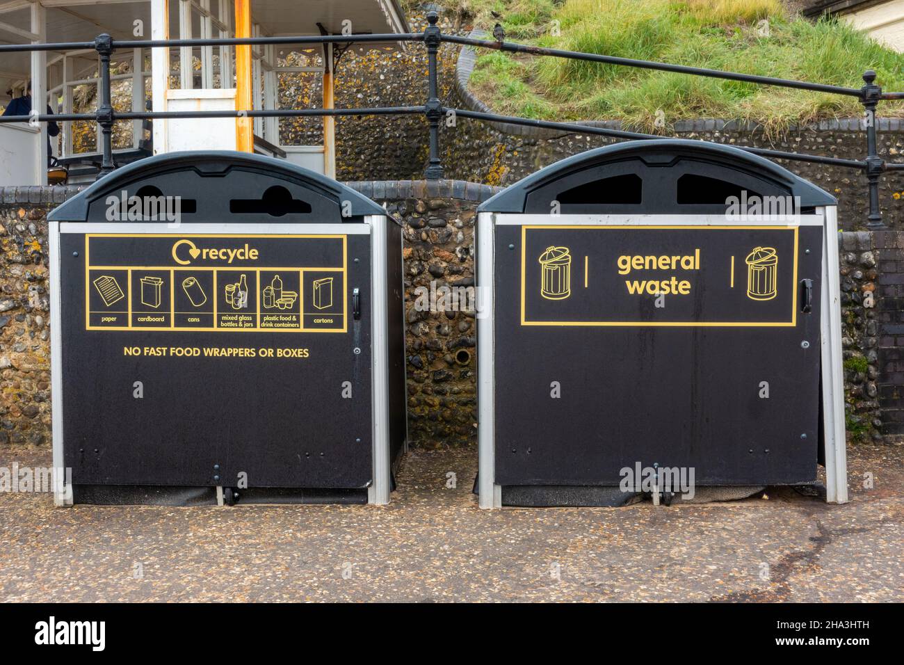 Two bins one recycling and the other for general waste on a promenade ...
