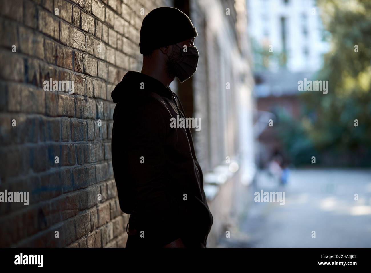 afro american man in black mask standing at street waiting for victim ...