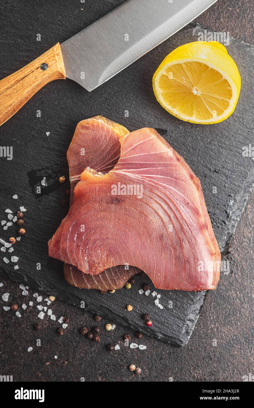 Raw tuna steak. Raw fish meat on black table. Top view Stock Photo - Alamy