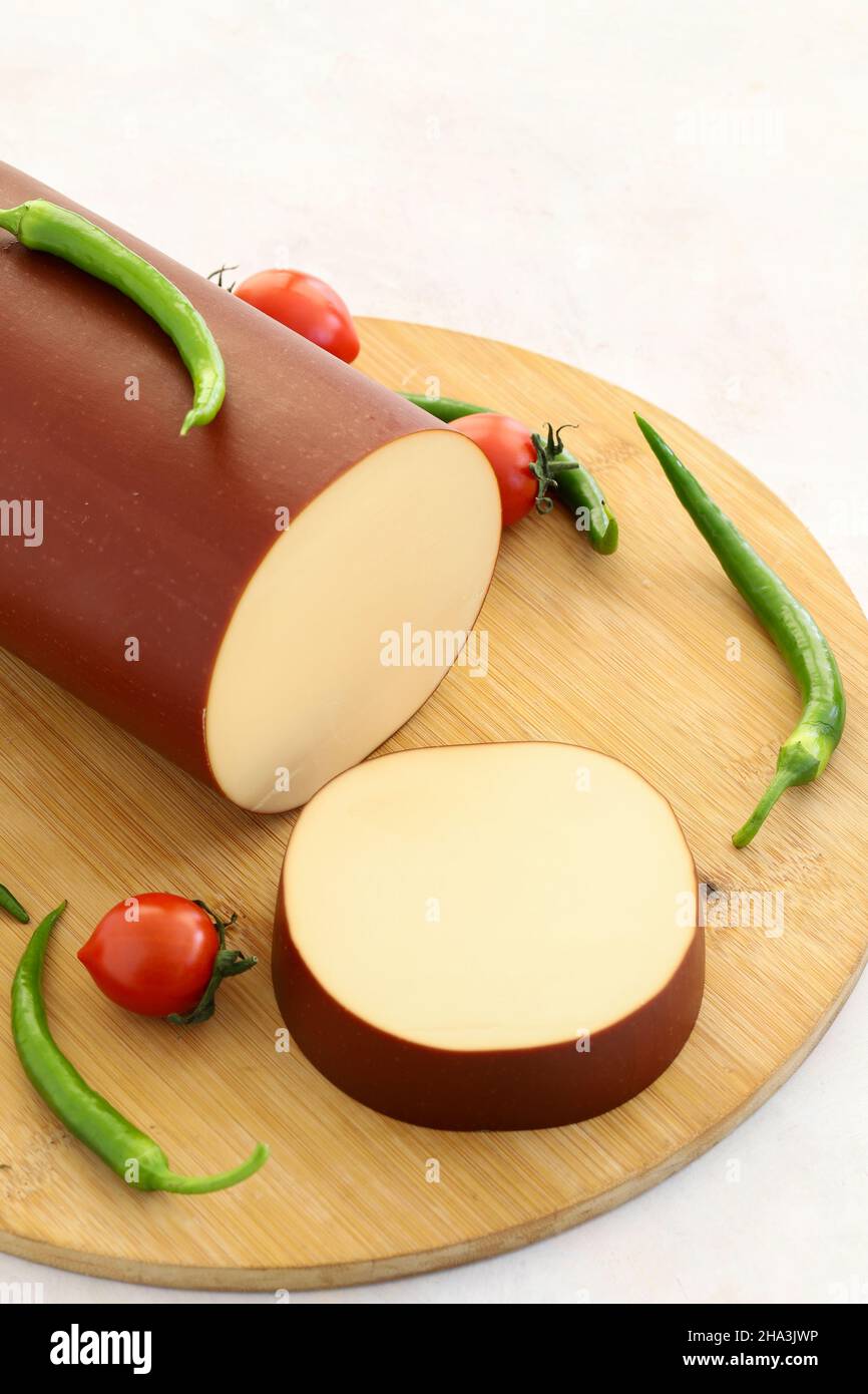 Smoked cheese with peppers on a white background. Local name biberli ...