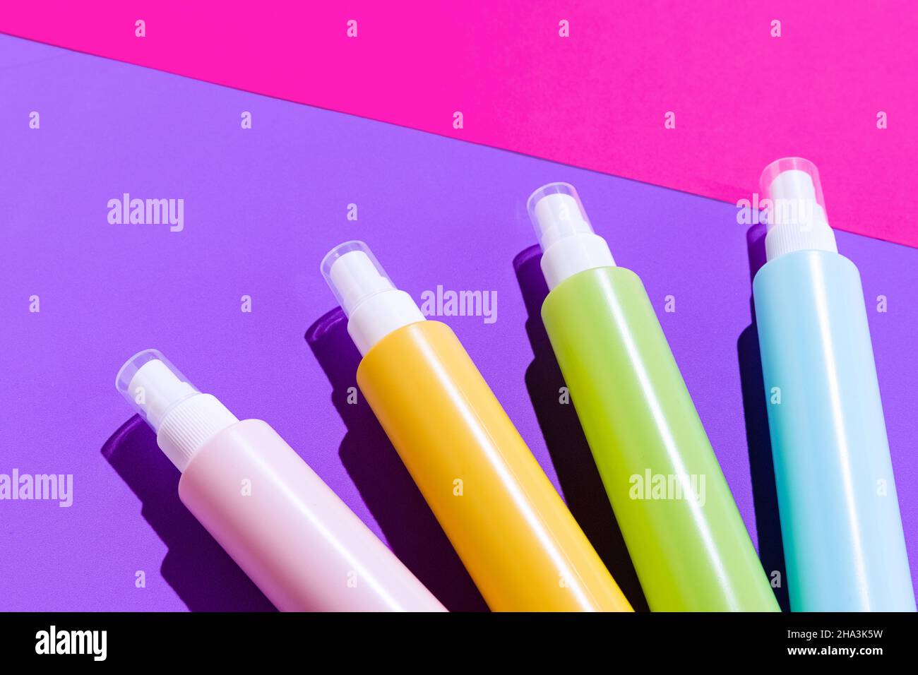 Set of bright color spray bottles for cosmetics, cream, lotion without ...