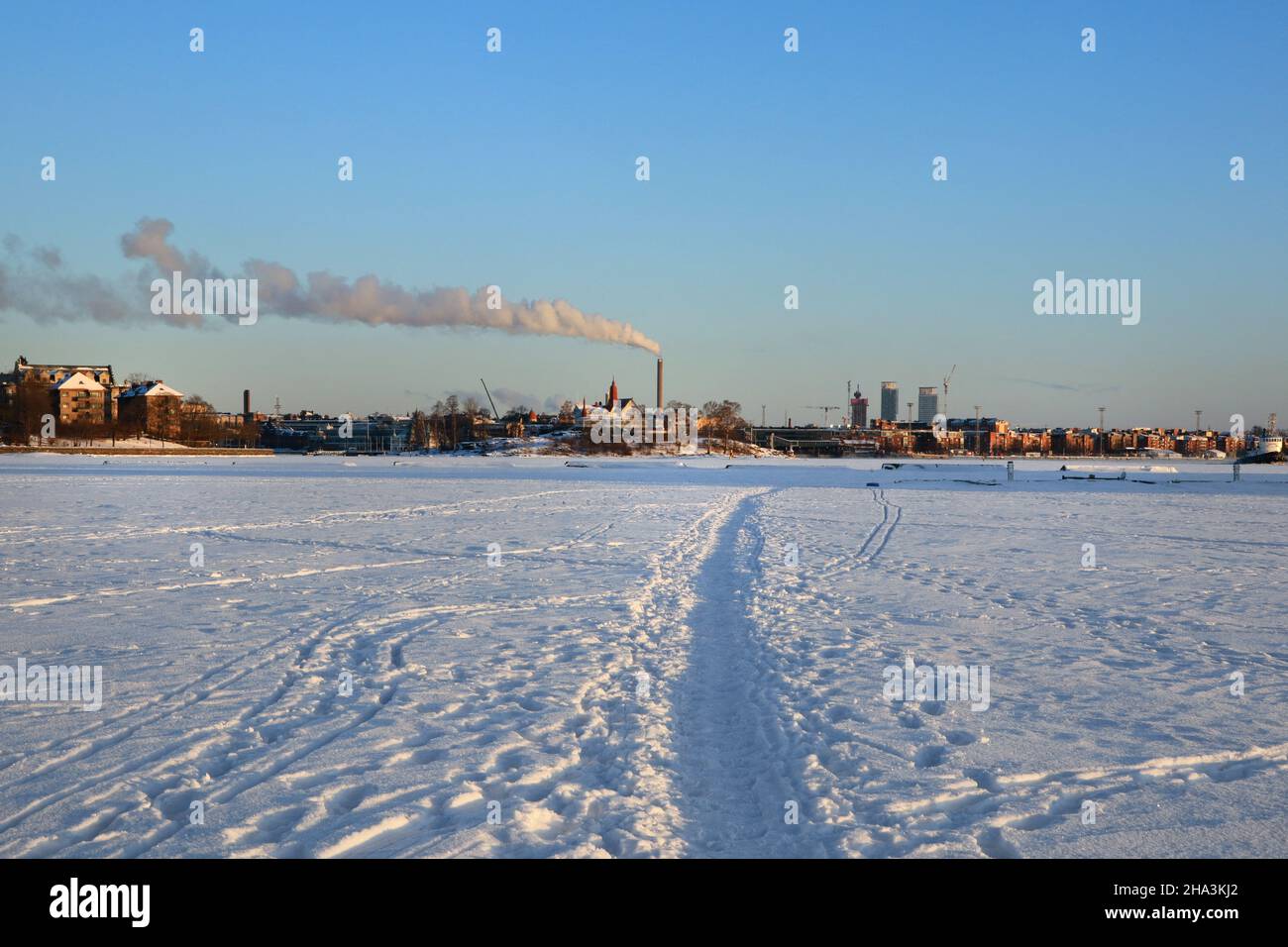 Footpath on frozen sea near shoreline in Helsinki, Finland towards ...