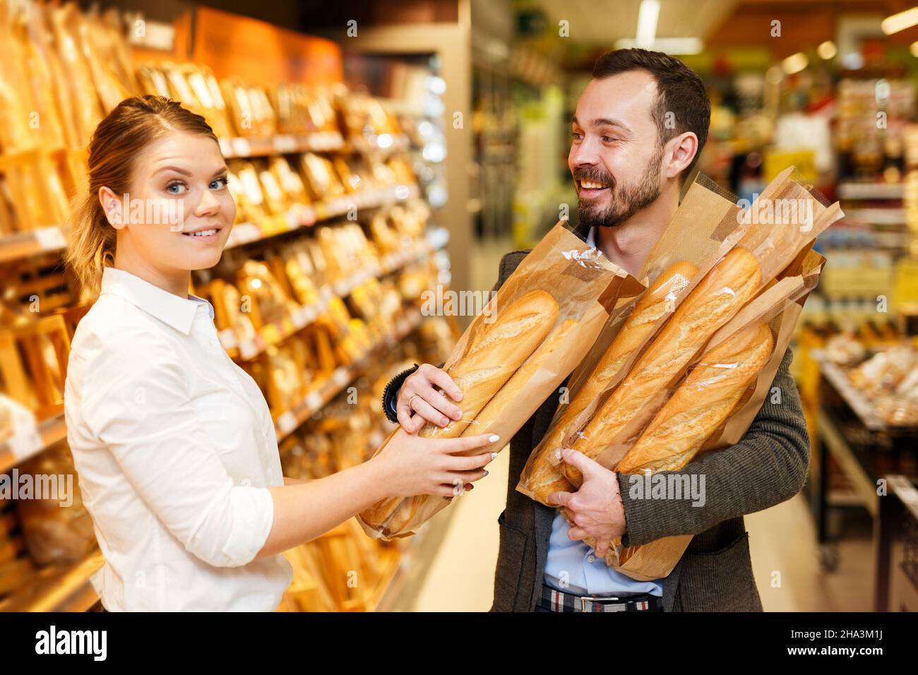 couple is standing with purchases in bread department Stock Photo - Alamy